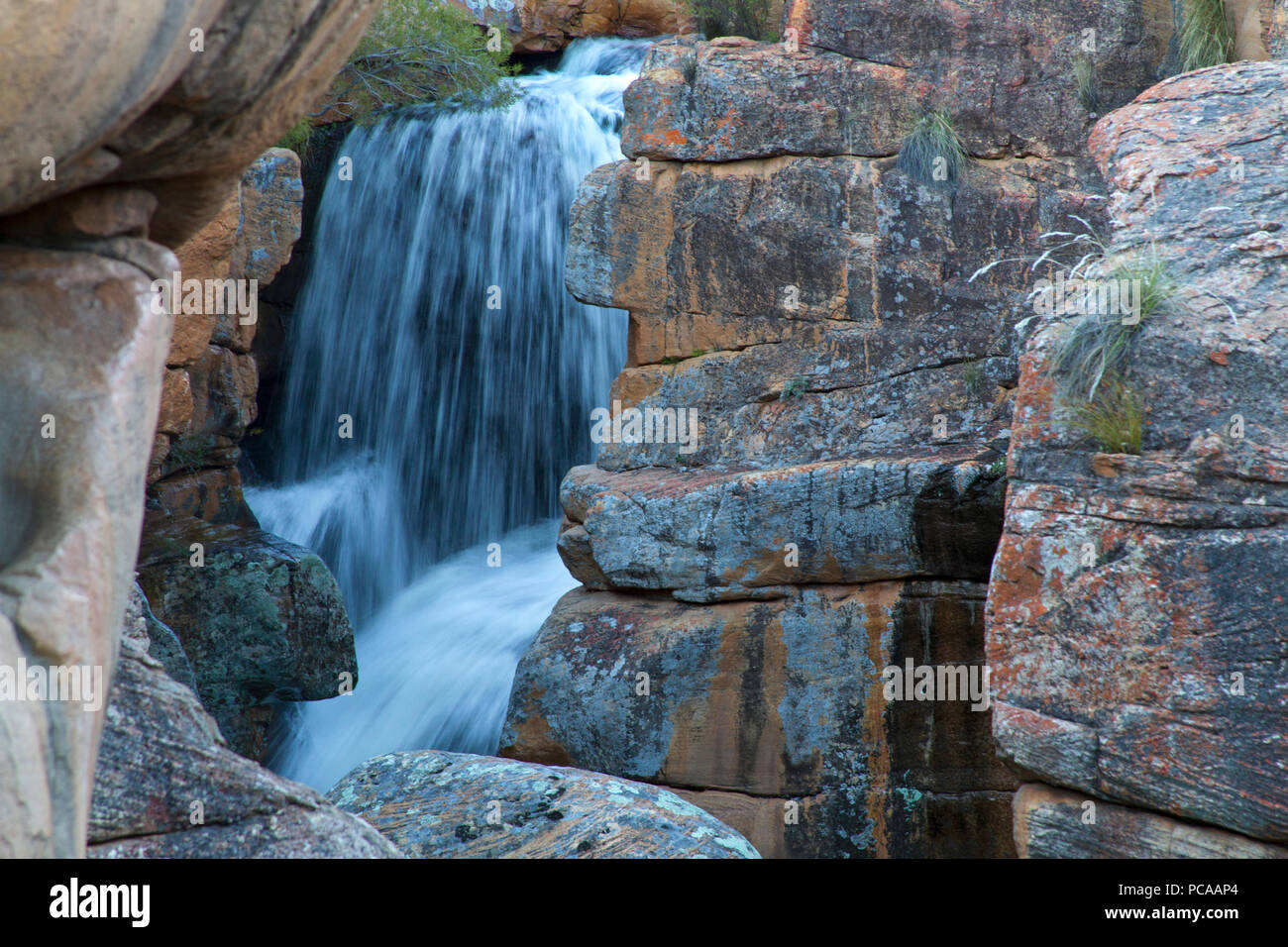 Water cascade between rocks Stock Photo - Alamy