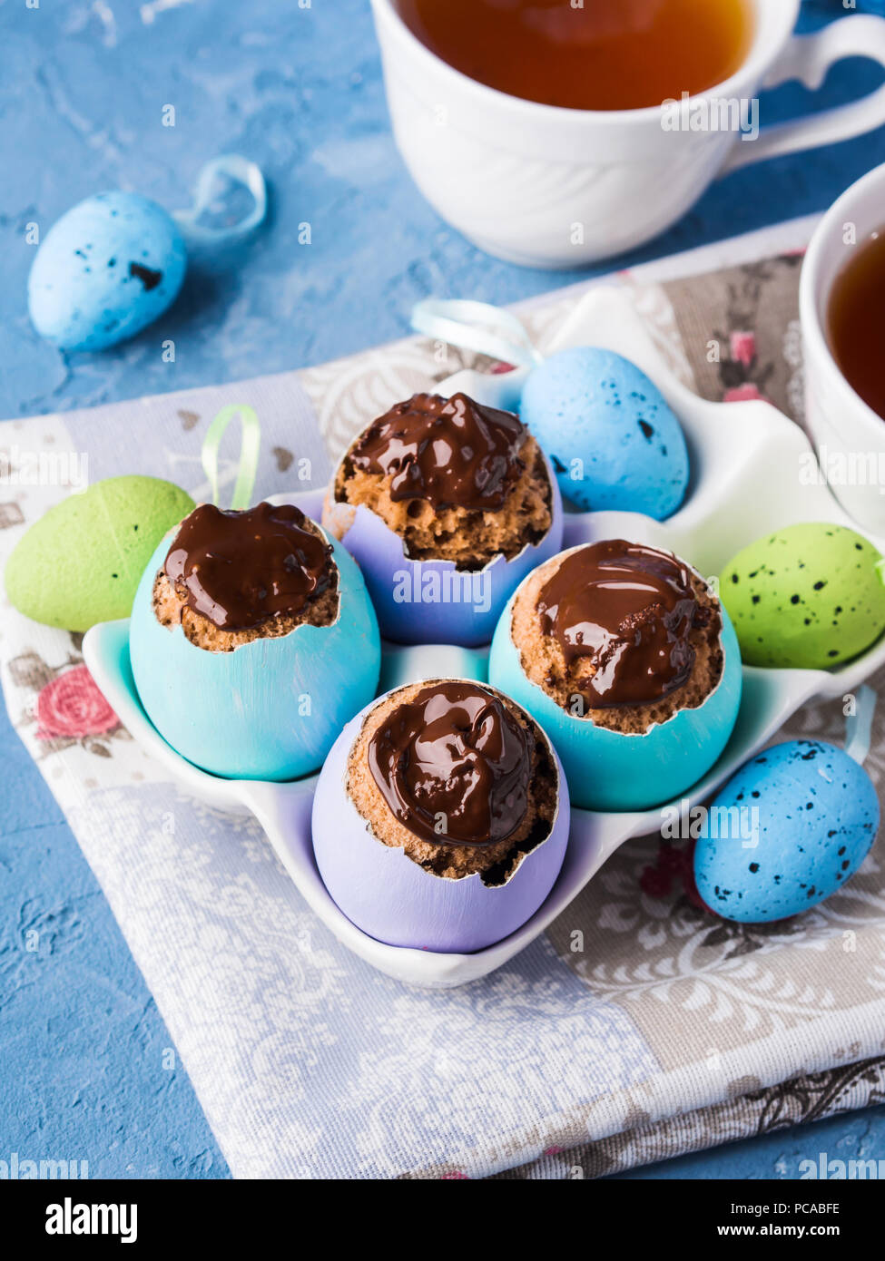 Easter blue background with cakes in colorful egg shells Stock Photo ...