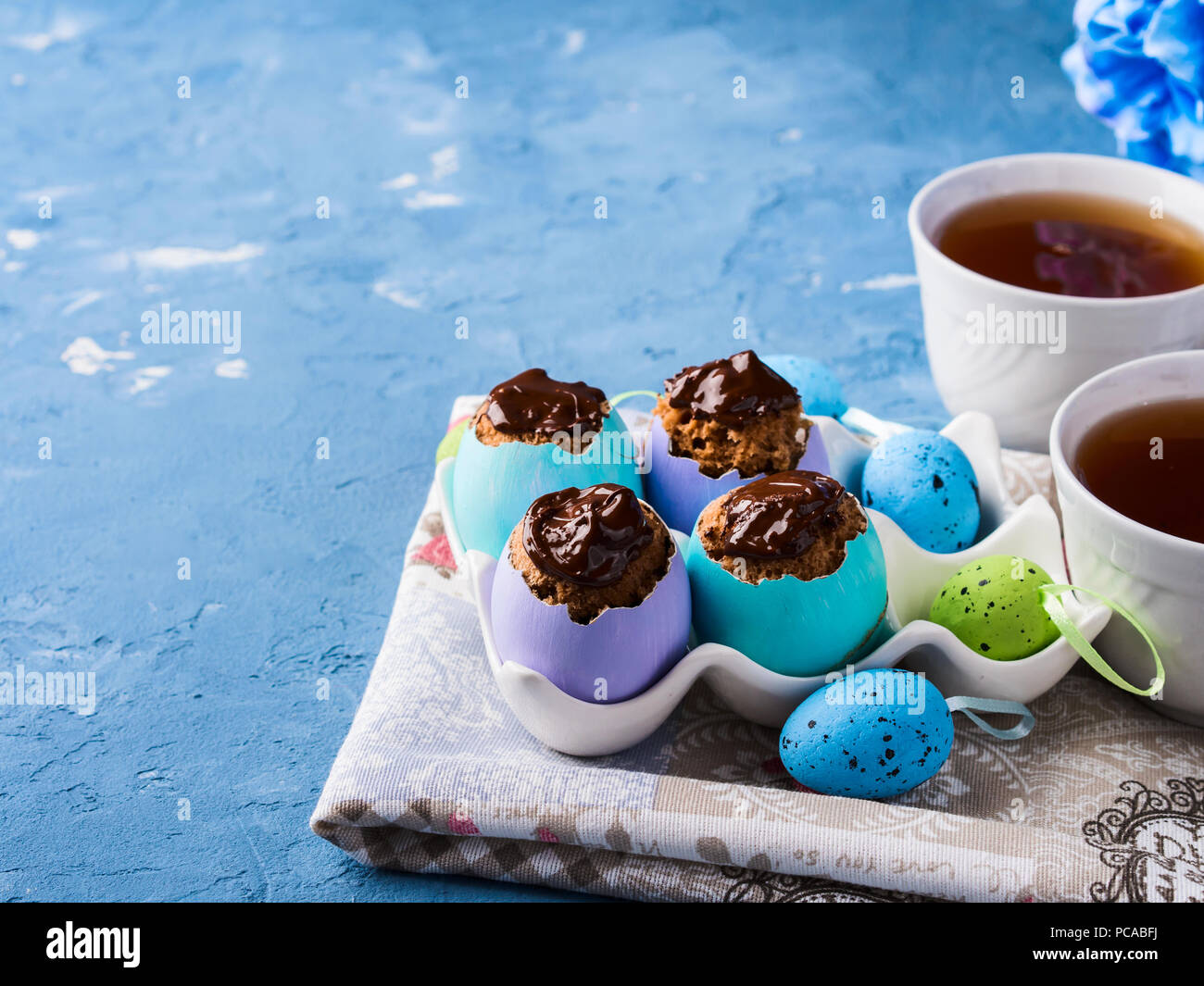 Easter blue background with cakes in colorful egg shells Stock Photo ...