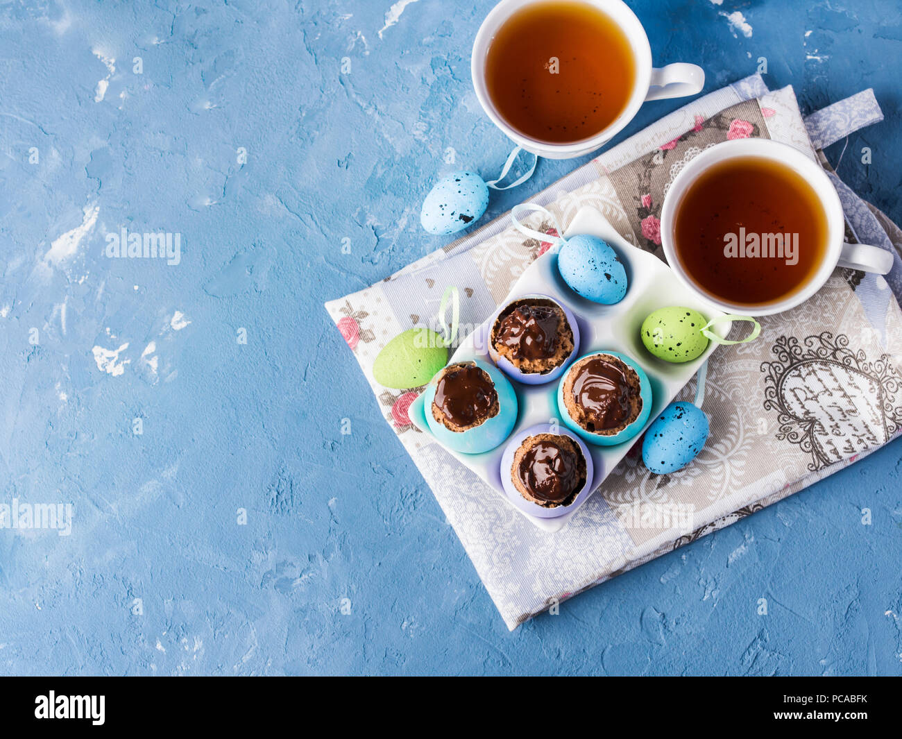 Easter blue background with cakes in colorful egg shells Stock Photo ...