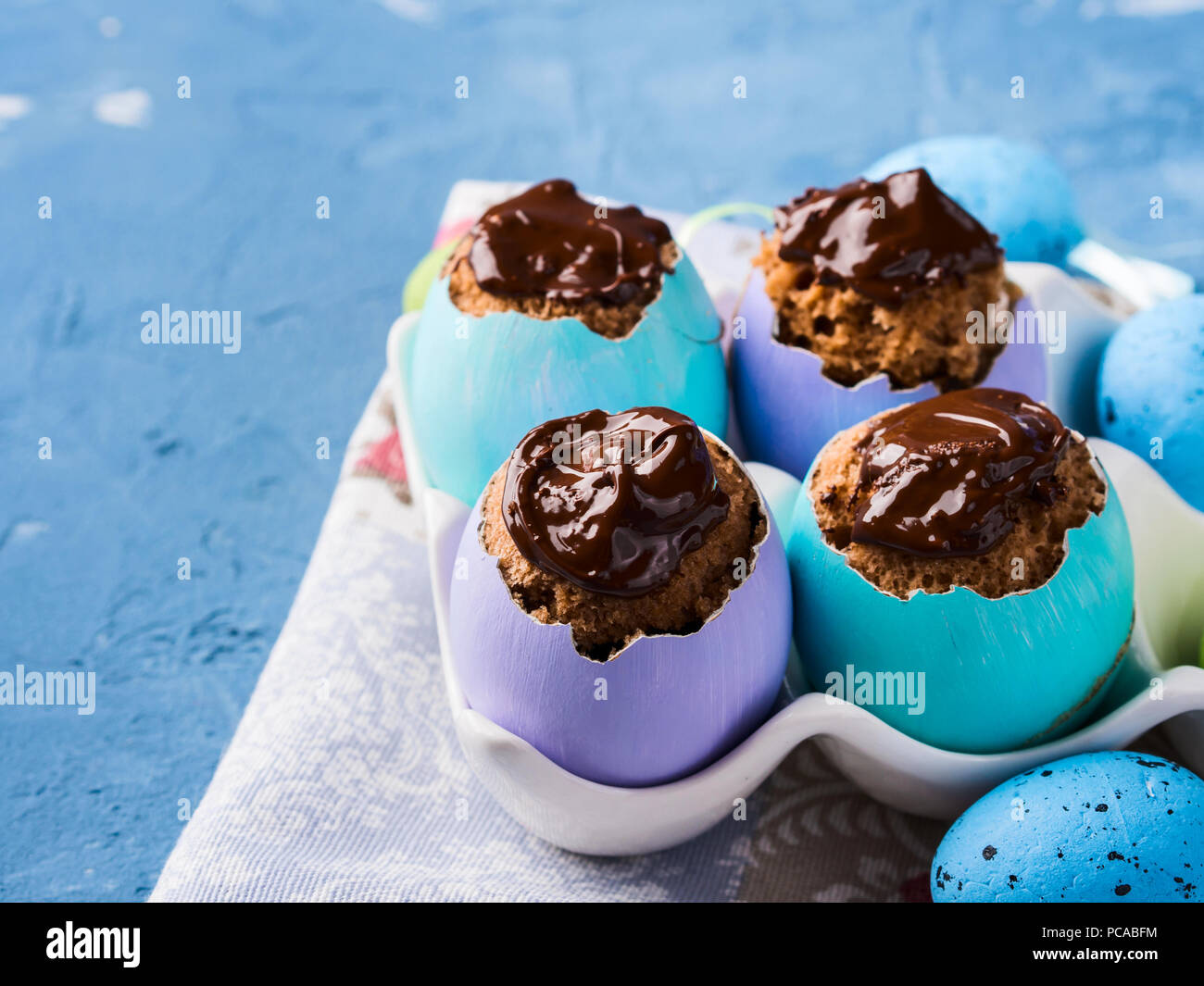 Easter blue background with cakes in colorful egg shells Stock Photo ...