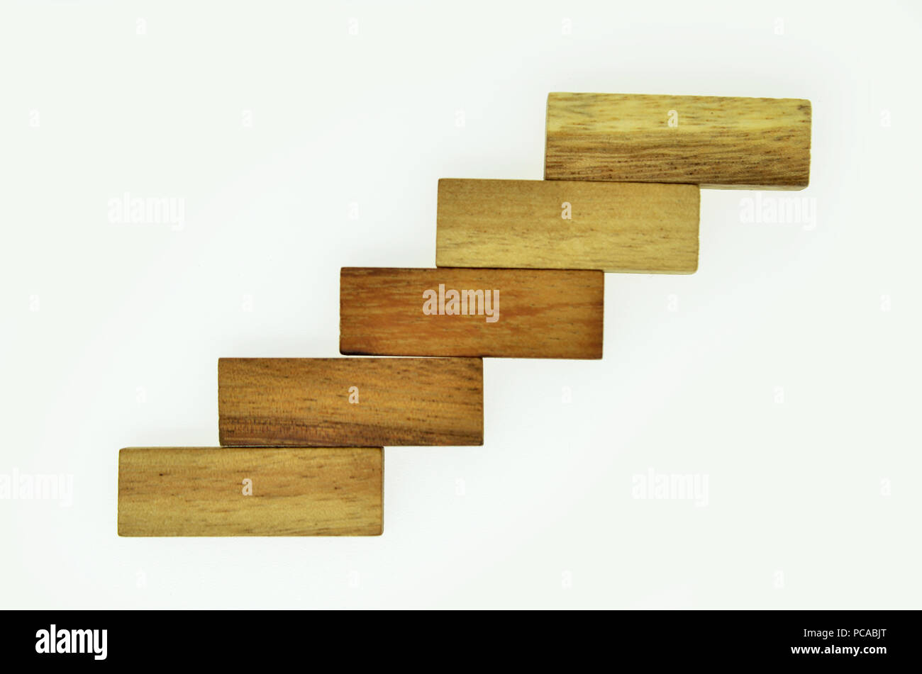 Wood block stacking as step stair isolated on white Stock Photo - Alamy