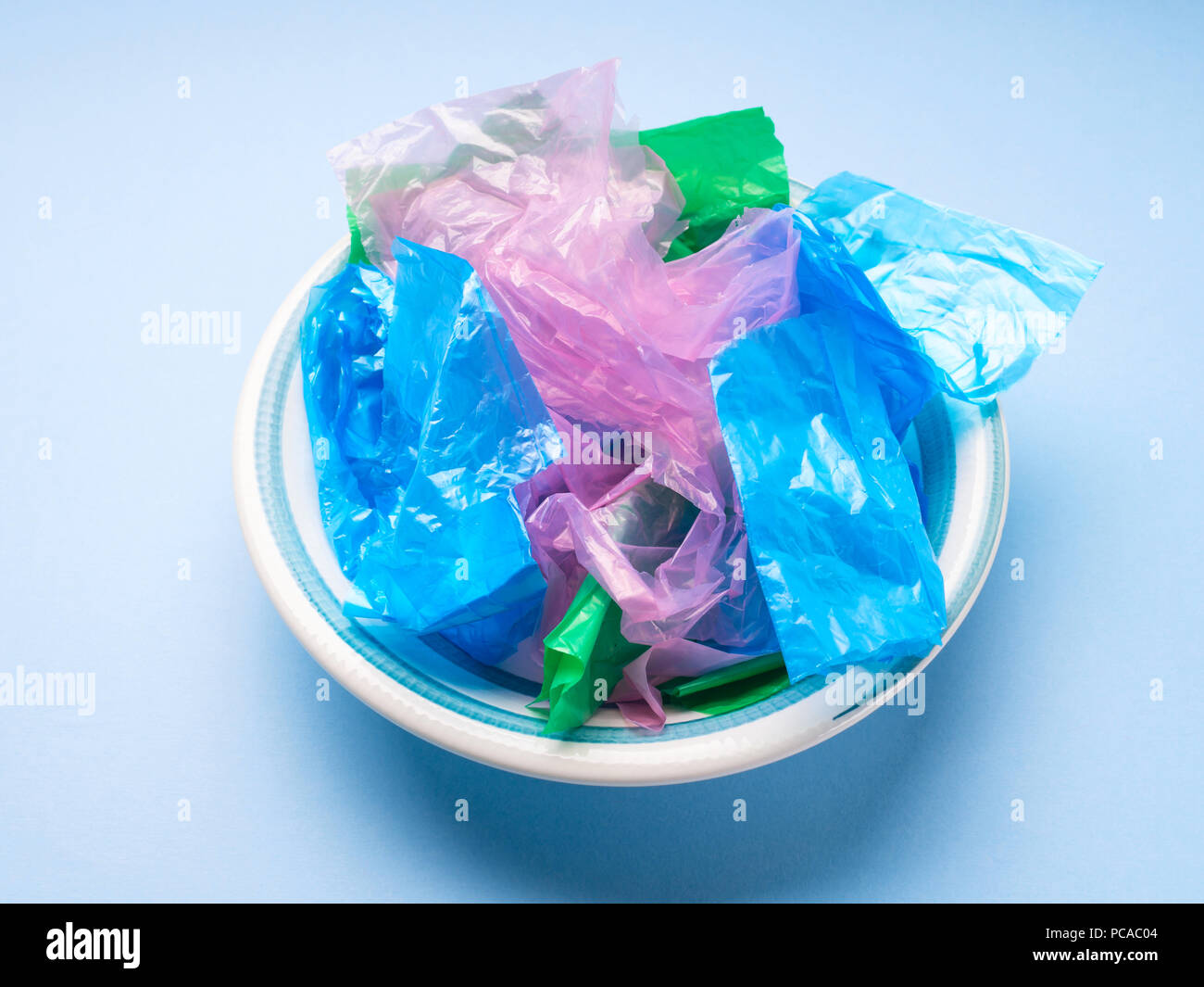 Colorful pastic bags in a dish texture closeup. Plastic use or disposal ...