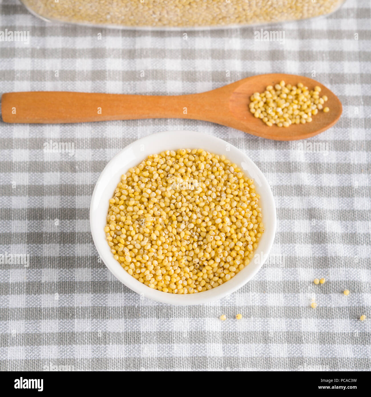 Gluten free grain millet in bowl on kitchen table. Celiac diet Stock ...
