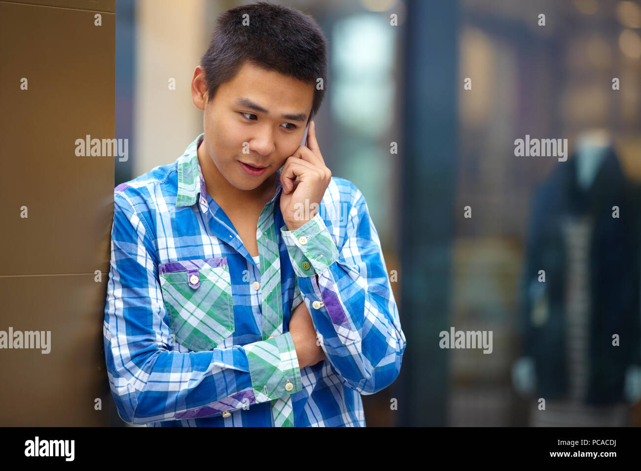 one young Chinese man talking on the phone Stock Photo - Alamy