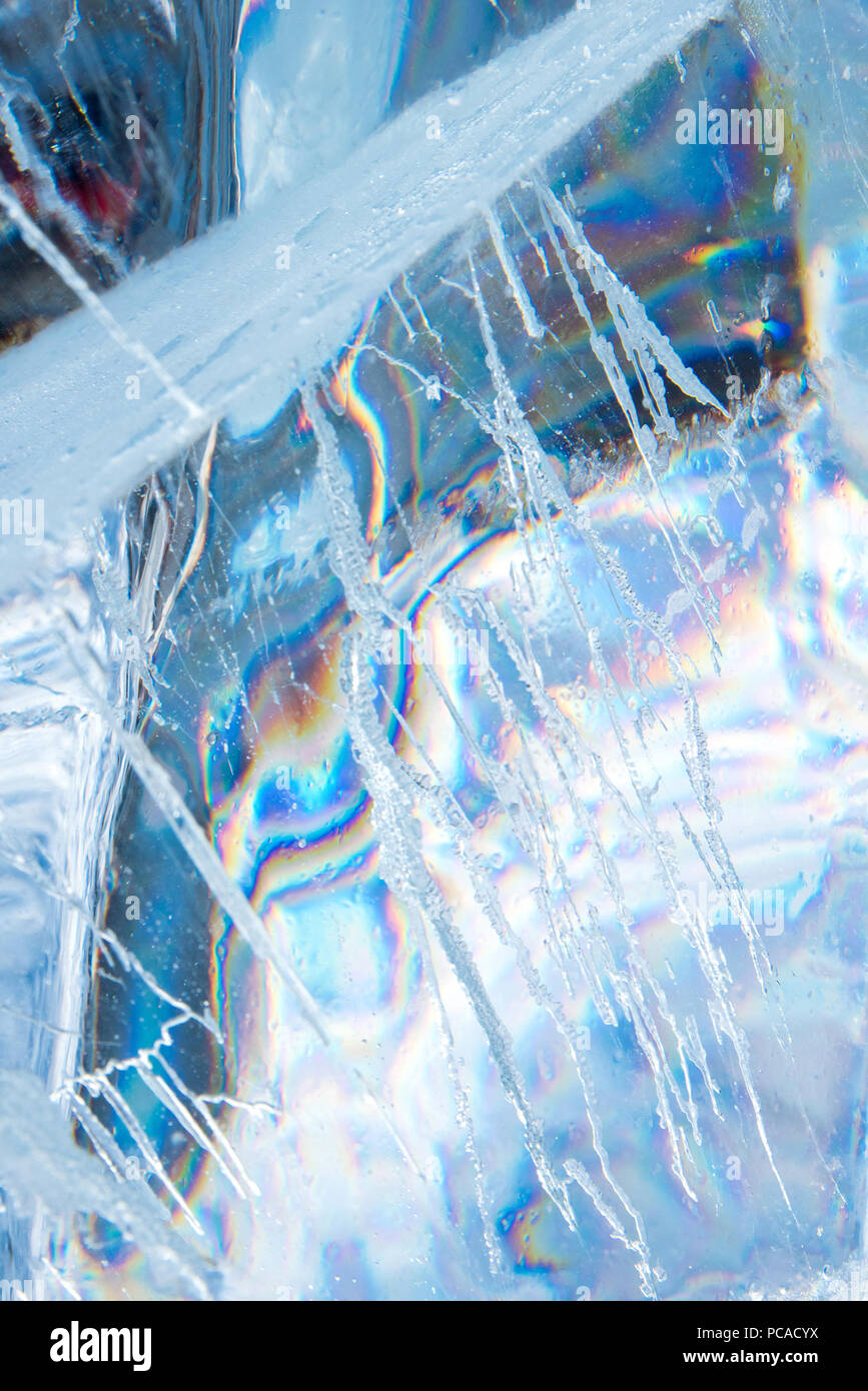 Beautiful abstract blue texture of transparent winter ice with rainbow ...