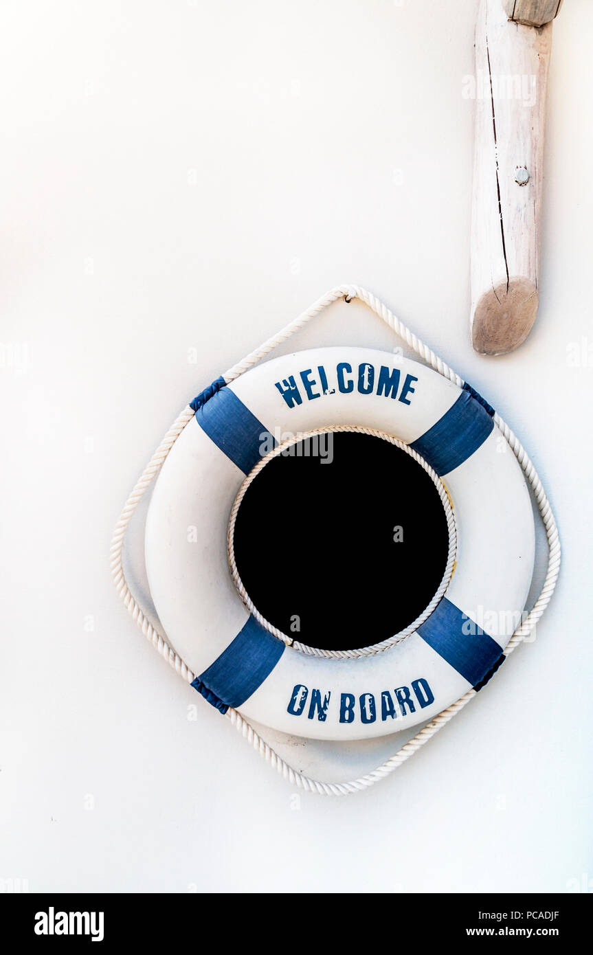 White and blue lifebuoy on white wall, float on the wall Stock Photo ...