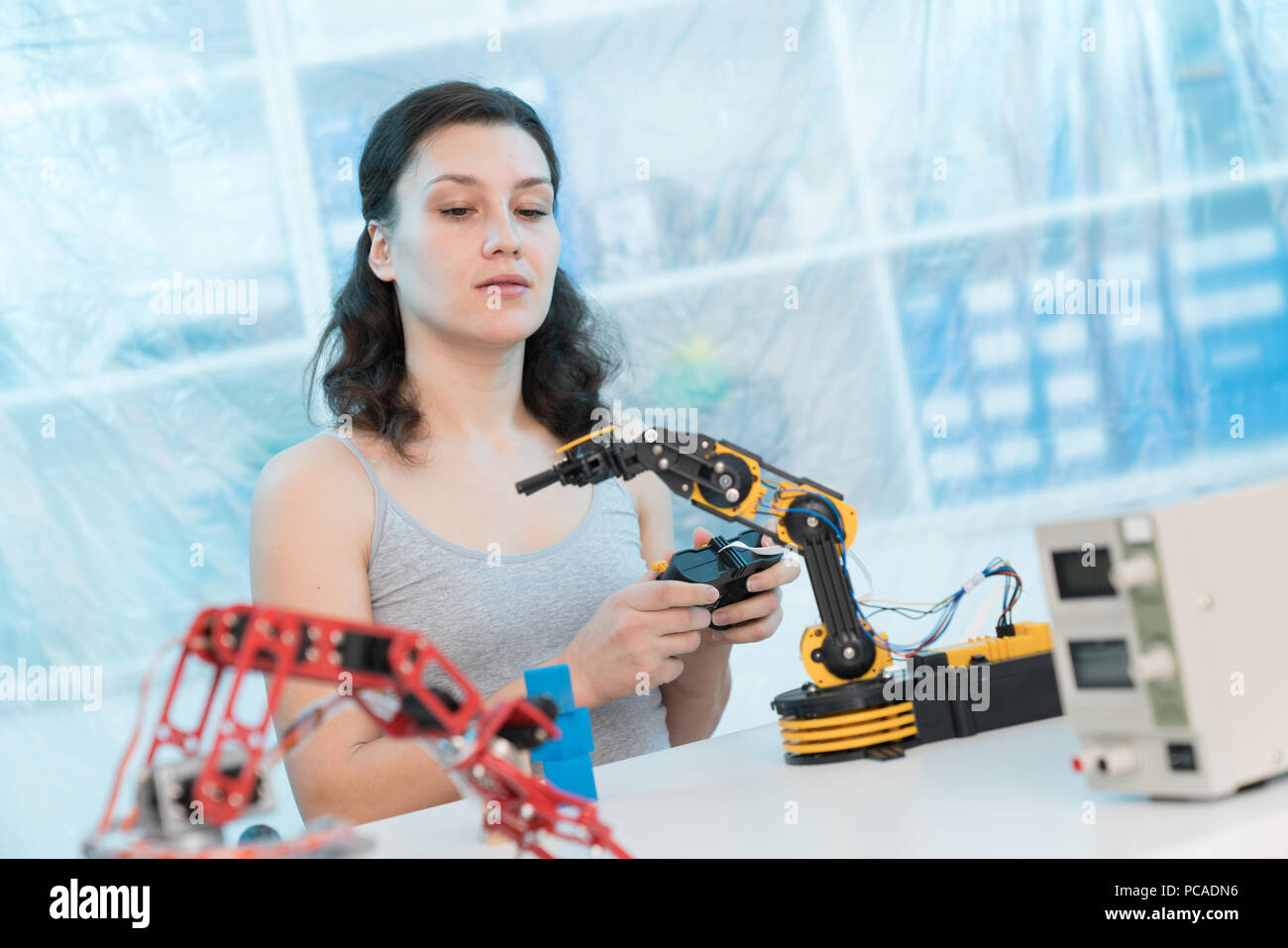 girl in a University laboratory is experimenting with a robot Stock ...