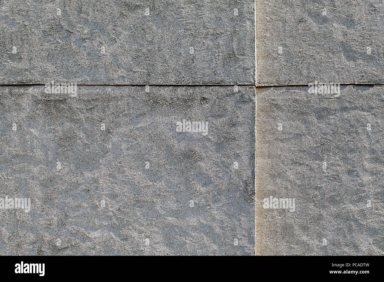 View of white rough wall decorated with calibrated quartz, marble ...
