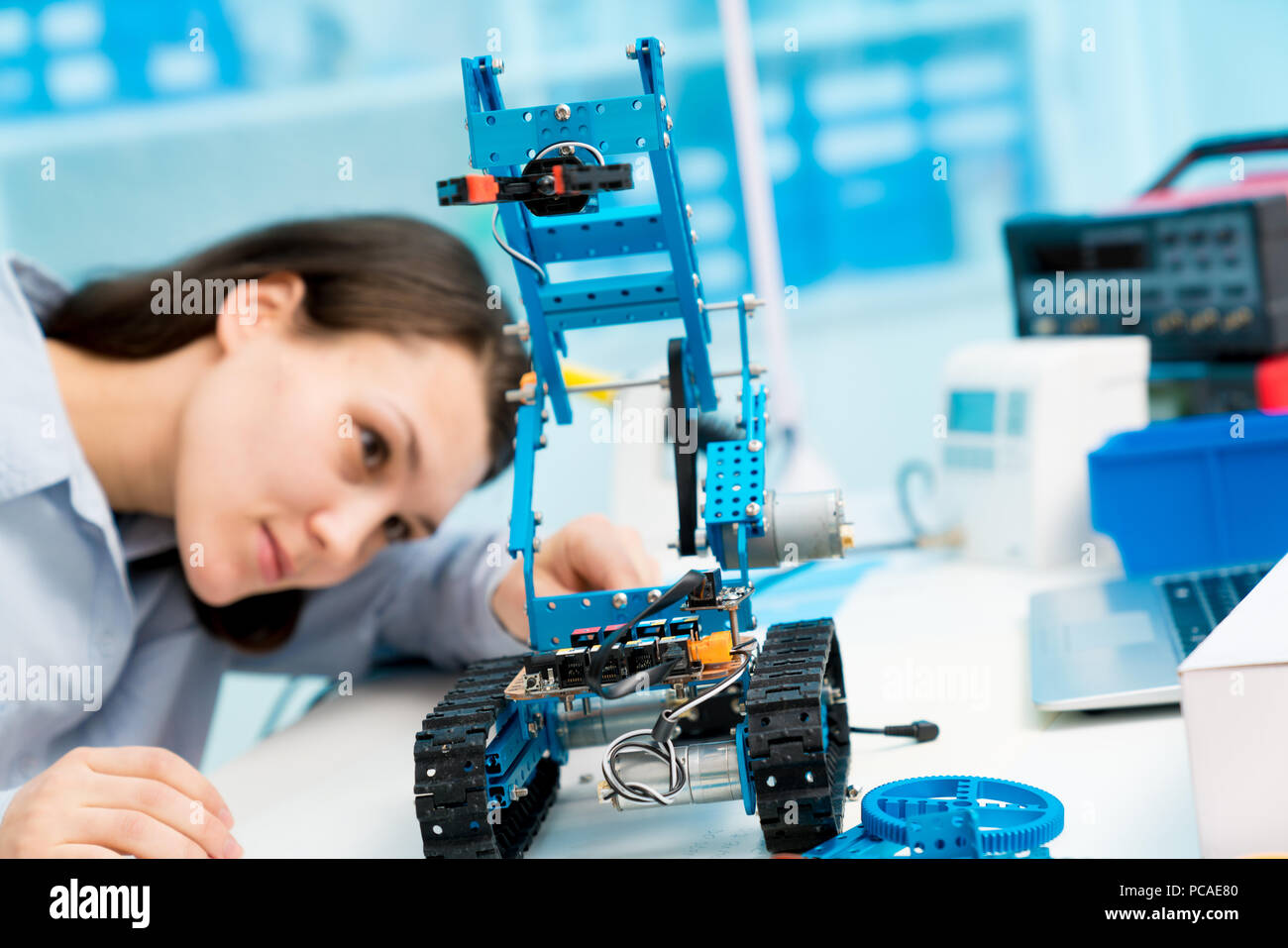 Student girl in electronics laboratory, experiment with microcontroller ...