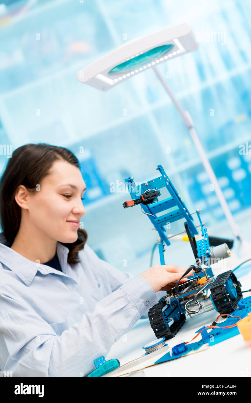 Student girl in electronics laboratory, experiment with microcontroller ...