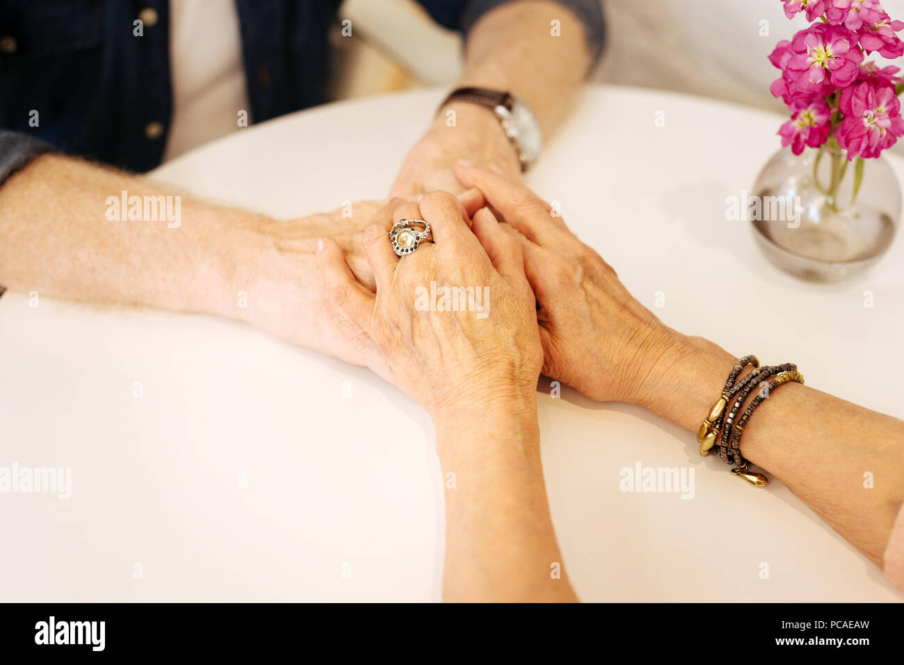 Senior male and female hands keeping together Stock Photo - Alamy