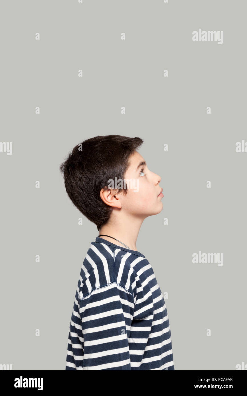 Sweet boy wearing striped shirt, profile view Stock Photo - Alamy