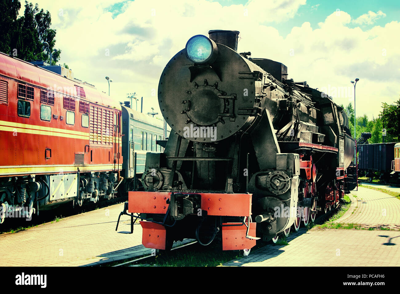 Latvia, Riga. July 2015. Vintage steam train and other trains at a ...