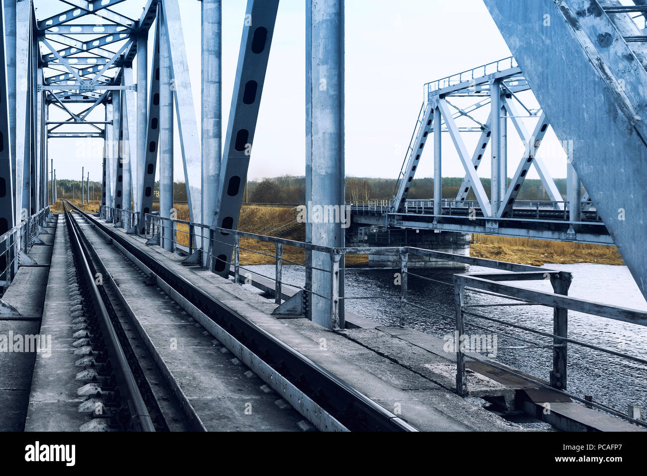 Steel railway bridge across the river with the rails. Latvia, Europe ...