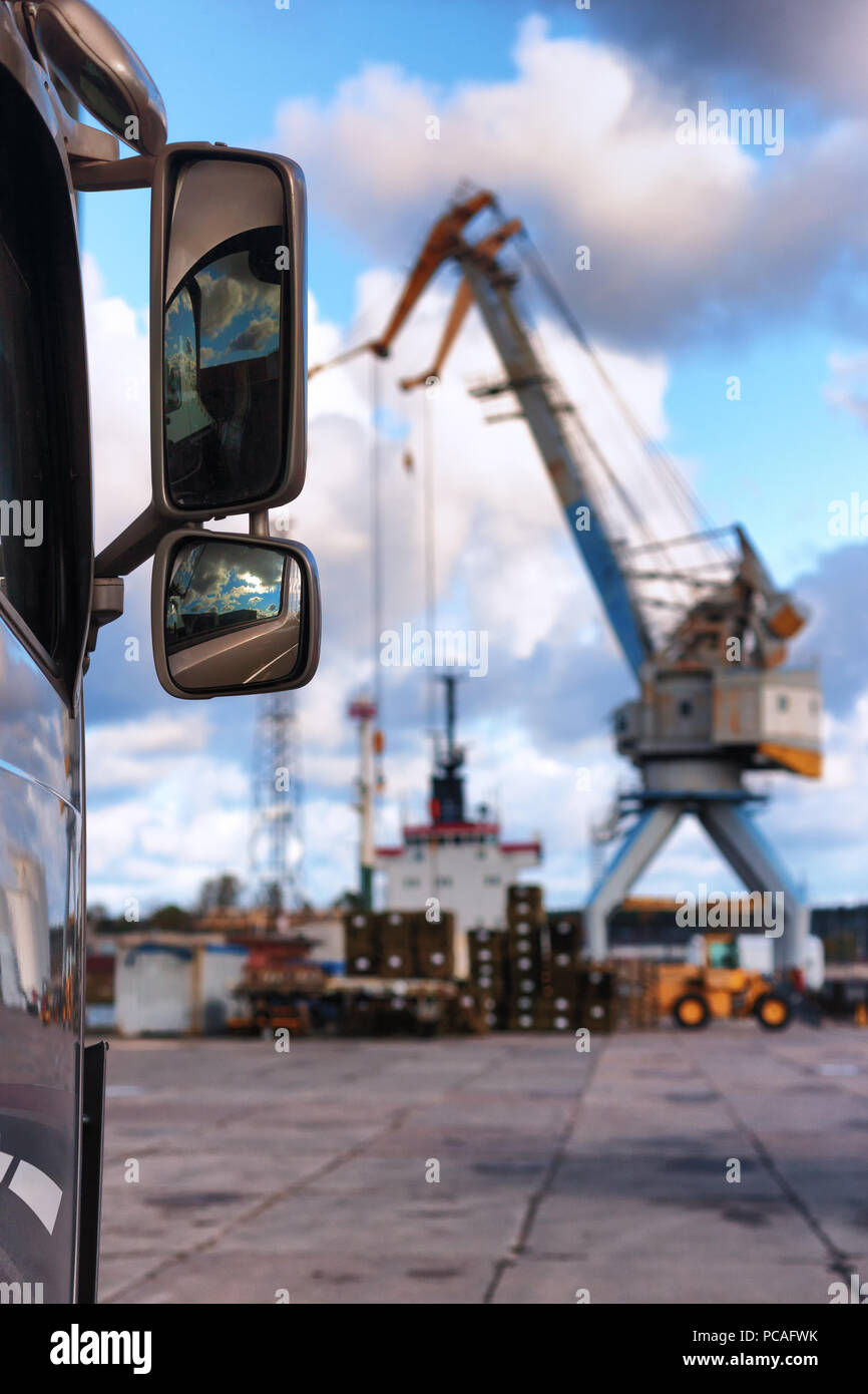 Mirrors truck on background loading and unloading of the ship cranes ...
