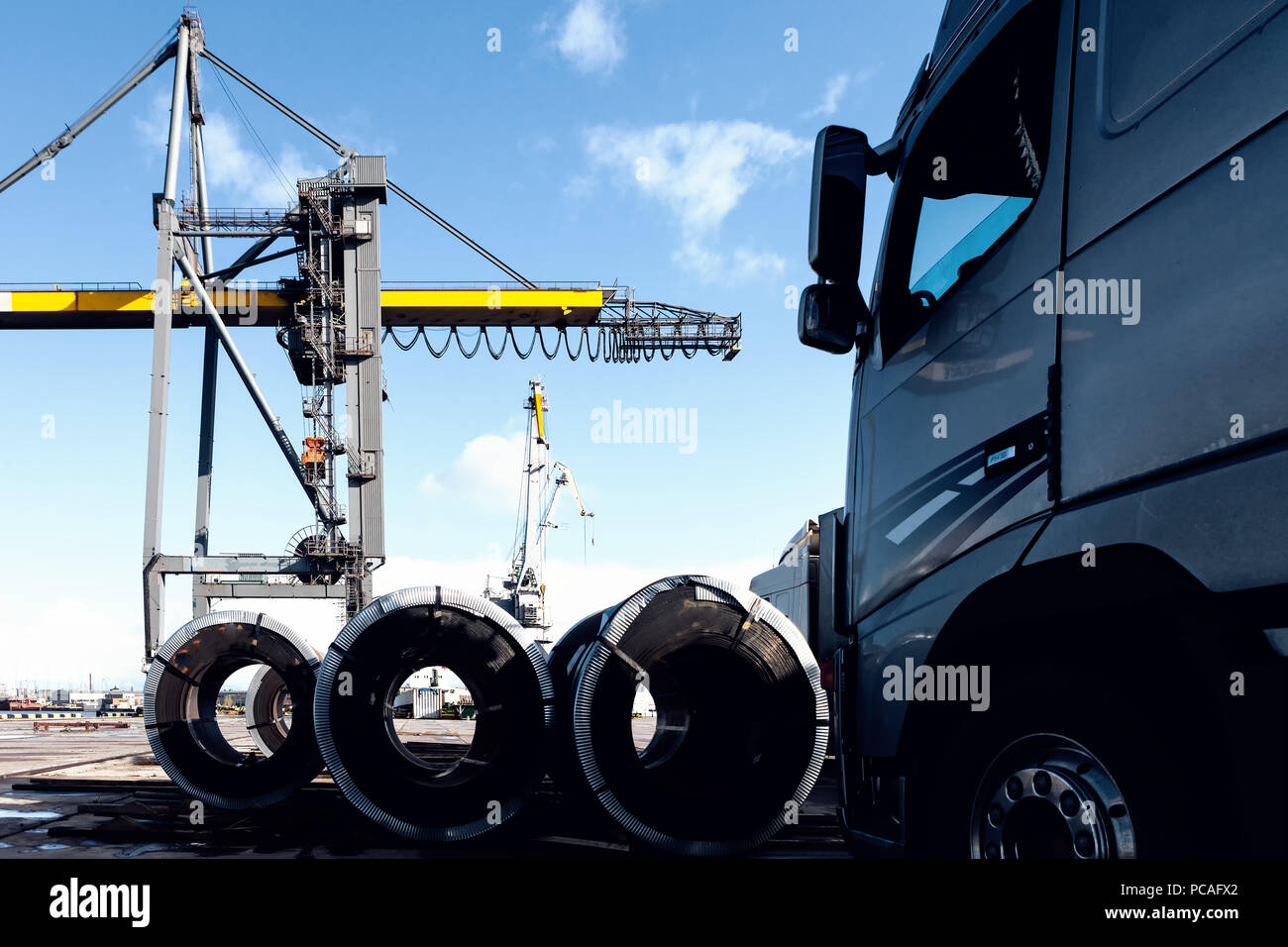 Container ship loading steel plates hi-res stock photography and images ...