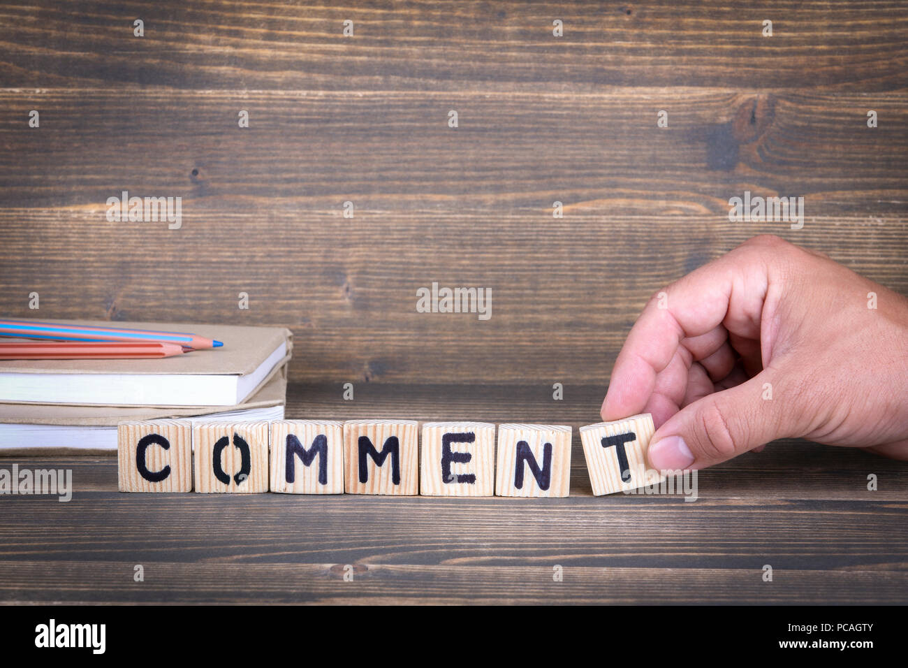 comment. wooden letters on the office desk Stock Photo - Alamy