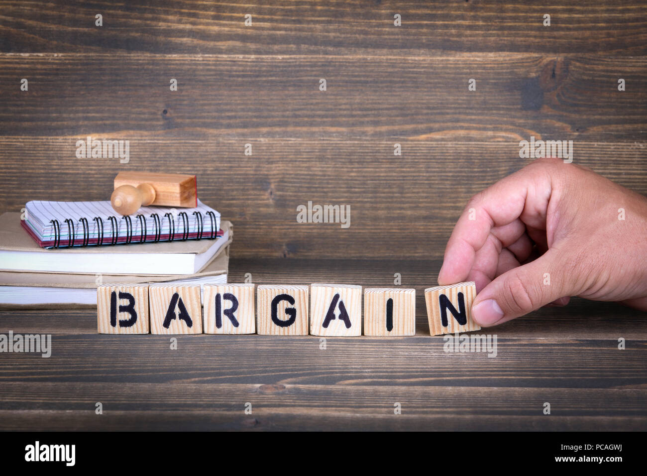 bargain. wooden letters on the office desk Stock Photo - Alamy