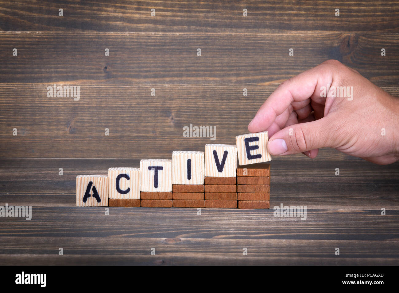 active. wooden letters on the office desk Stock Photo - Alamy