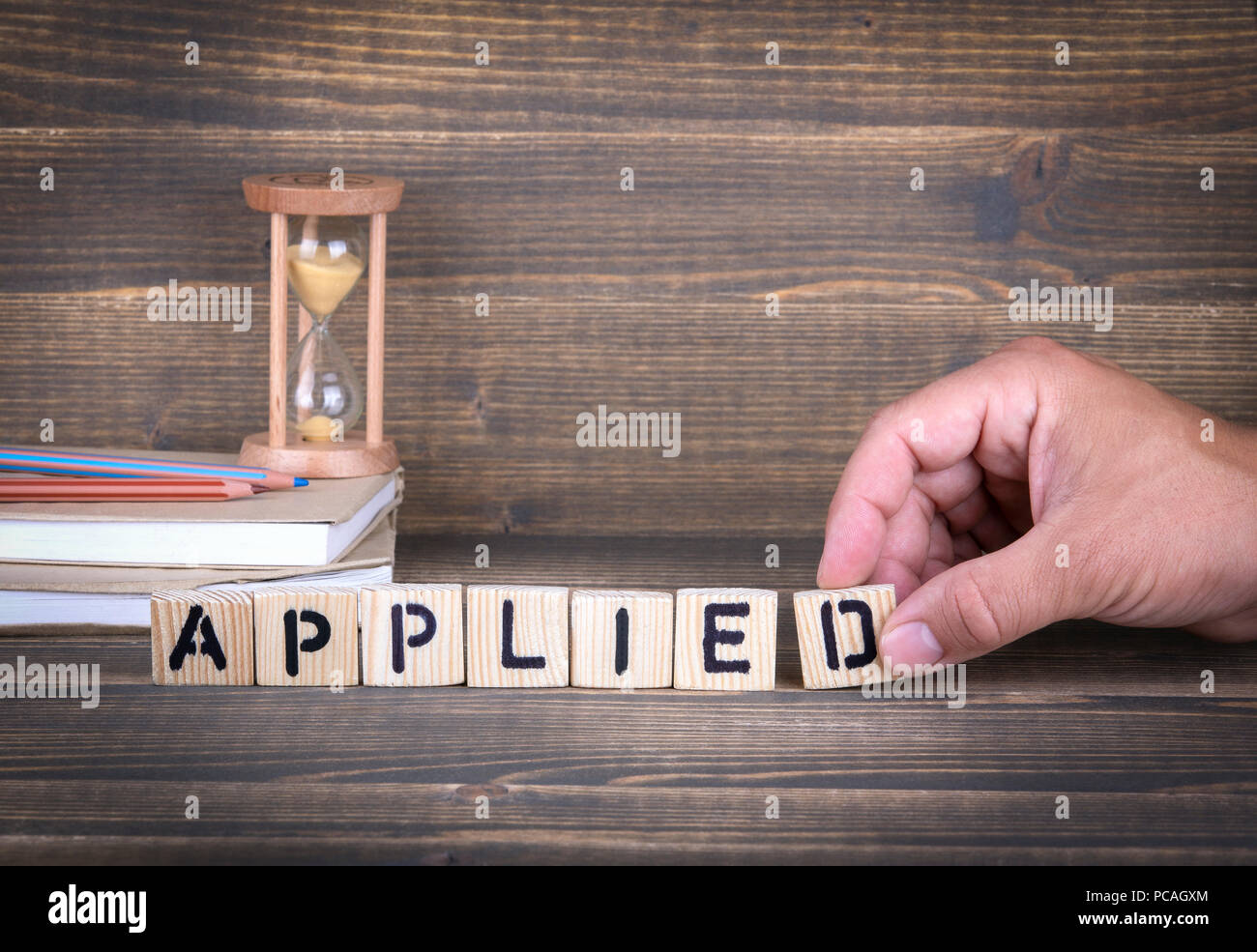 applied. wooden letters on the office desk Stock Photo - Alamy