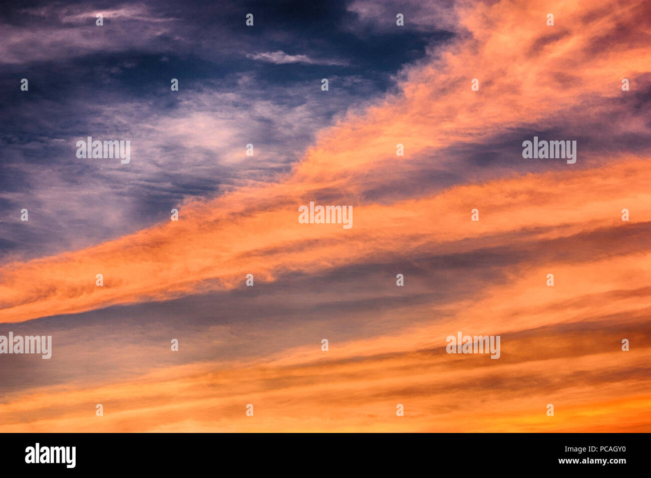 Golden Hour clouds, near the Dusk, with a hard dark blue sky and golden ...