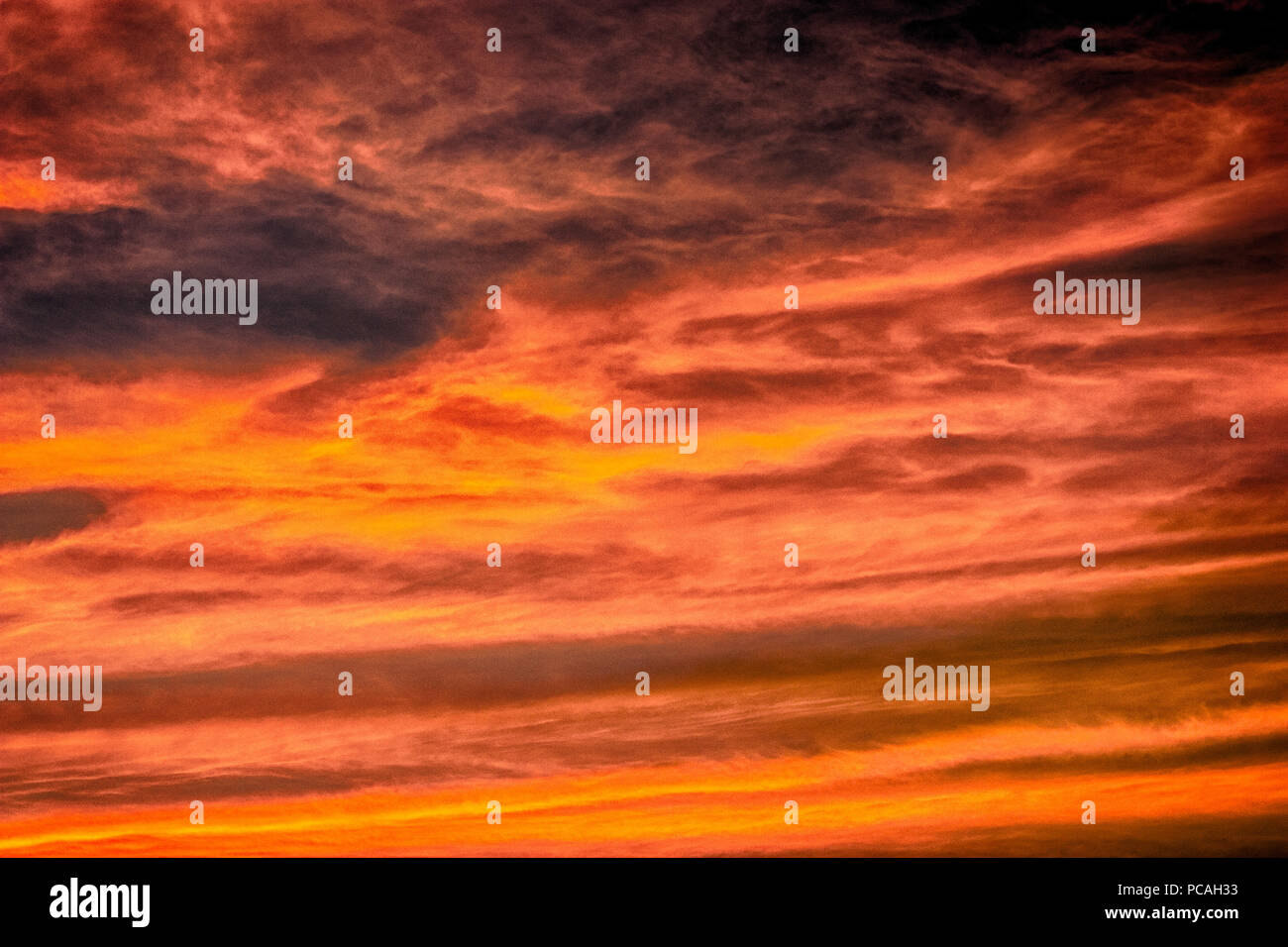 Golden Hour clouds, near the Dusk, with a hard dark blue sky and golden ...