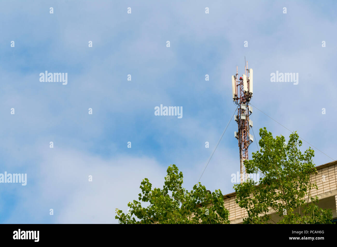 Telecommunications tower cells for mobile communications oh roof of building Stock Photo - Alamy