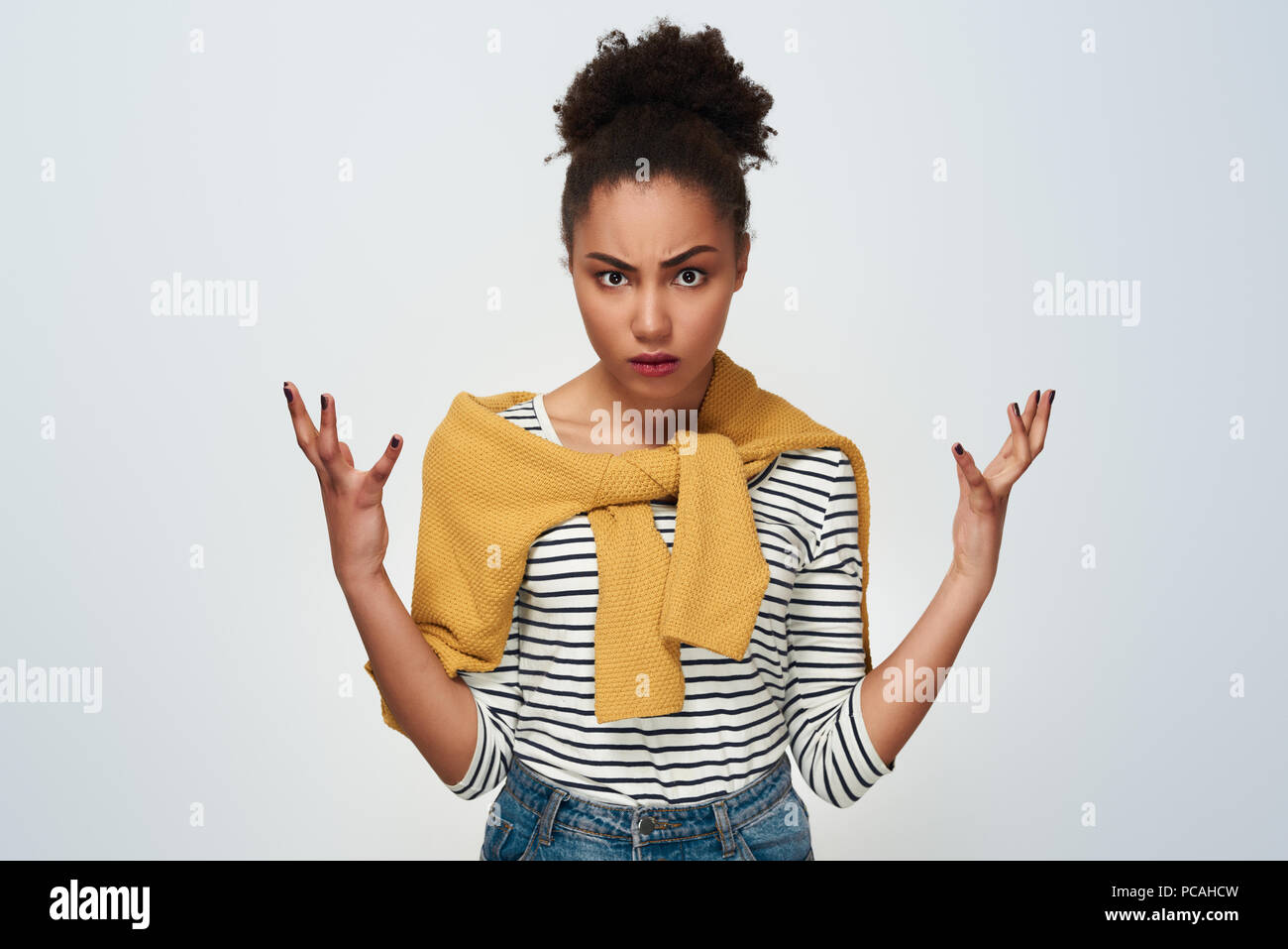 Young woman studio isolated in white looking camera angry Stock Photo ...