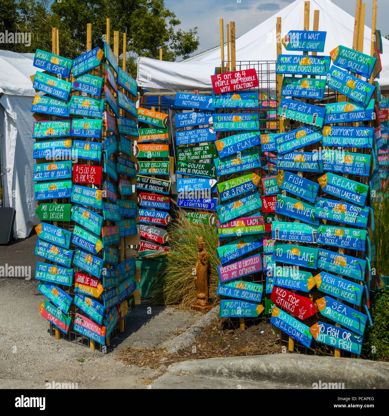 Display of colorful signs of many different sayings at a flea market ...