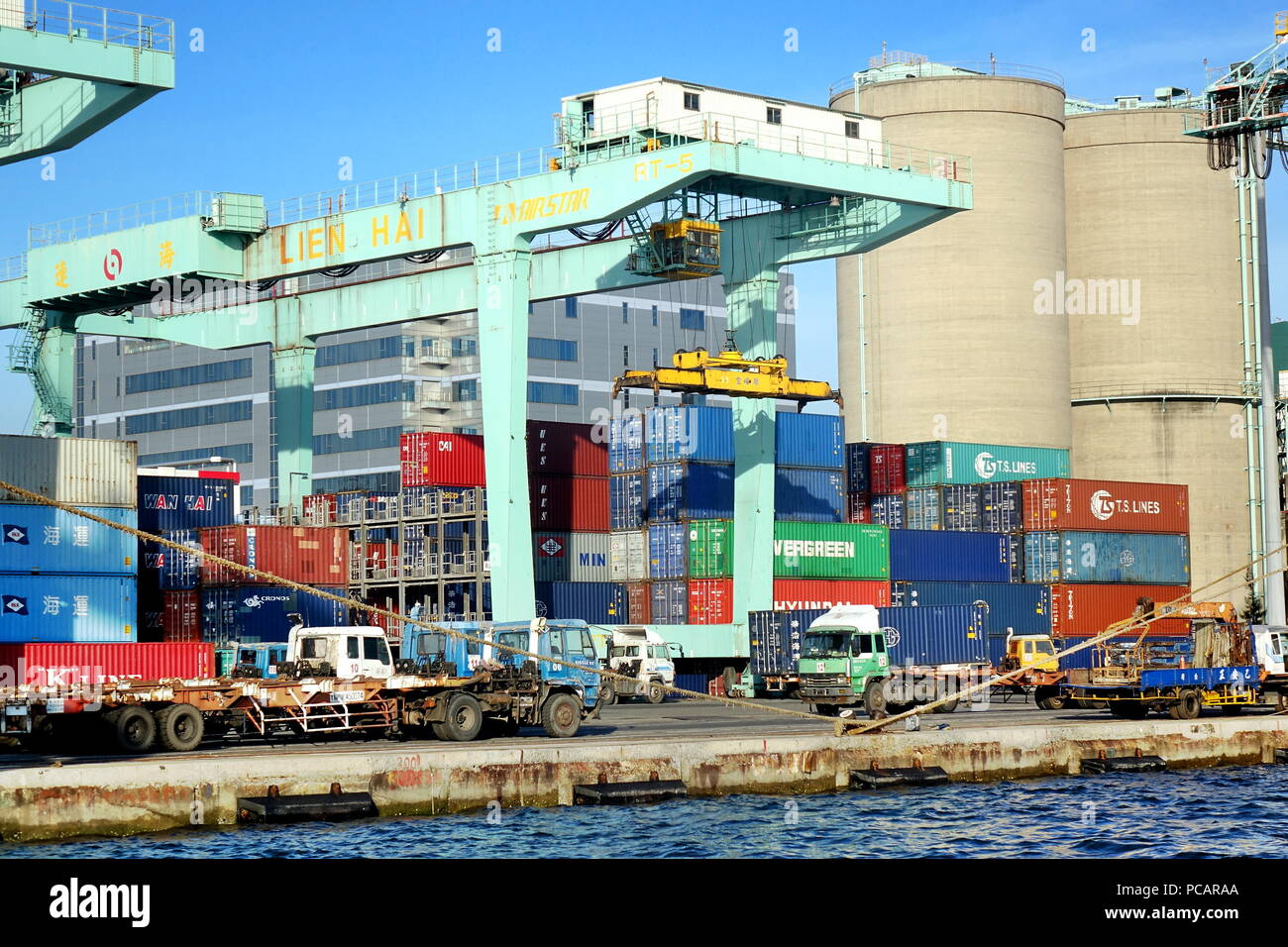 KAOHSIUNG, TAIWAN -- MAY 26, 2018: A shipping container is being loaded ...