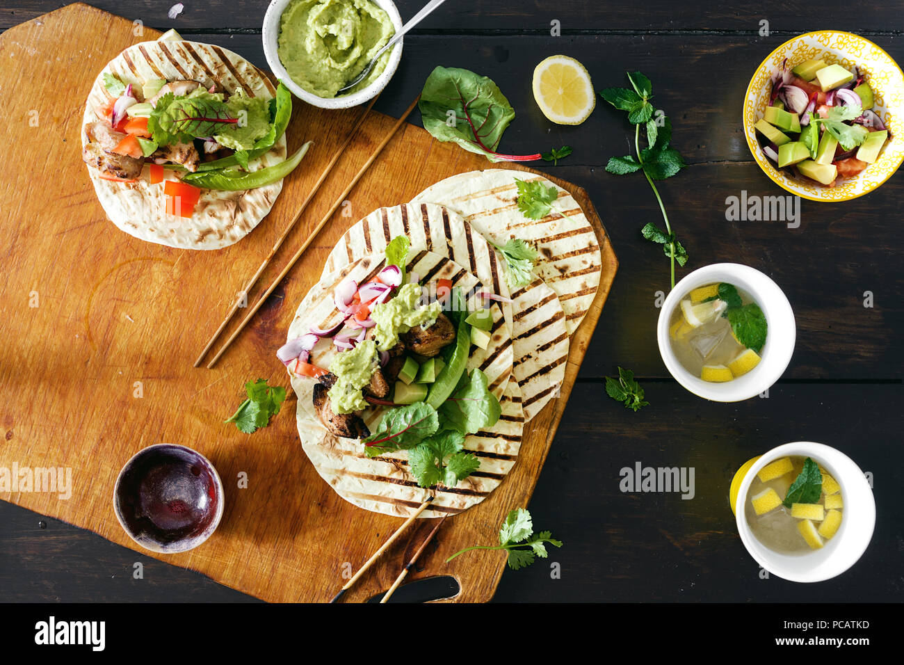 Dinner table with tacos grill with vegetable salsa, guacamole sauce ...