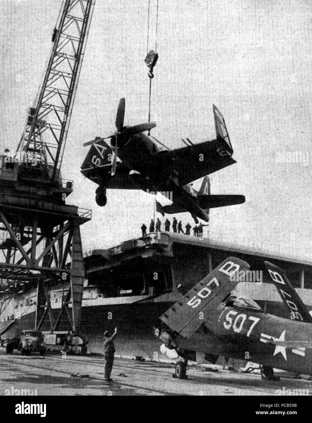 Aircraft are loaded on USS Boxer (CV-21) at NAS Alameda in 1950 Stock ...