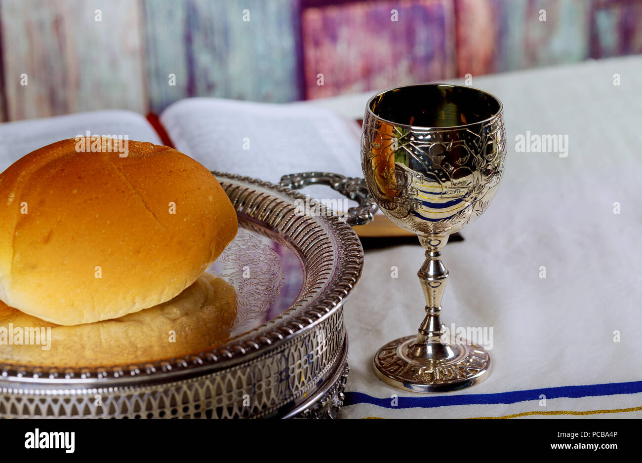 Taking Communion. Cup of glass with red wine, bread and Holy Bible on ...