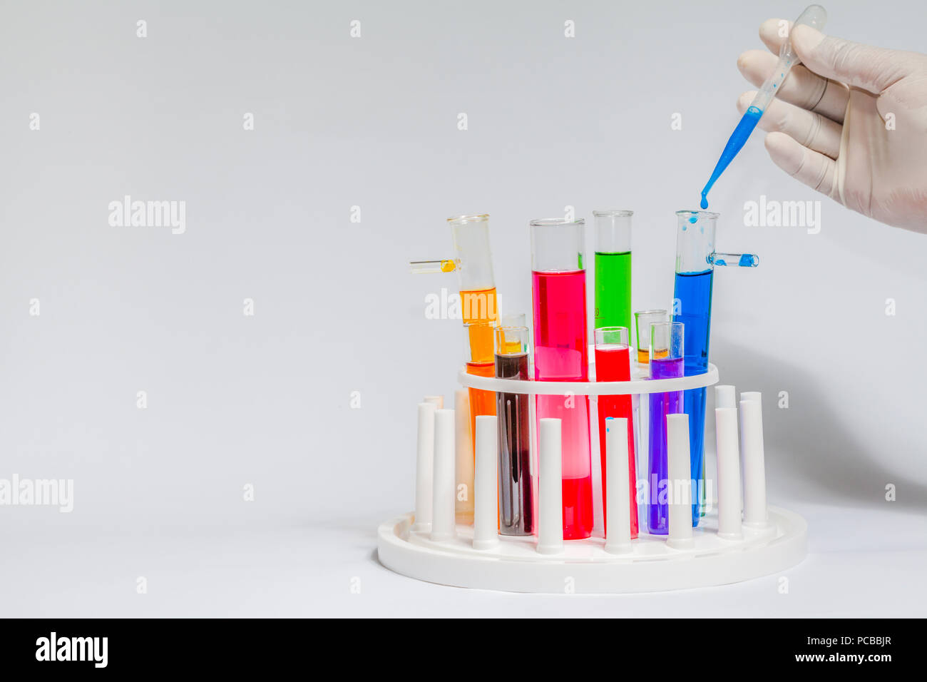 Experiments in mixing chemical substances into glass tubes with a ...