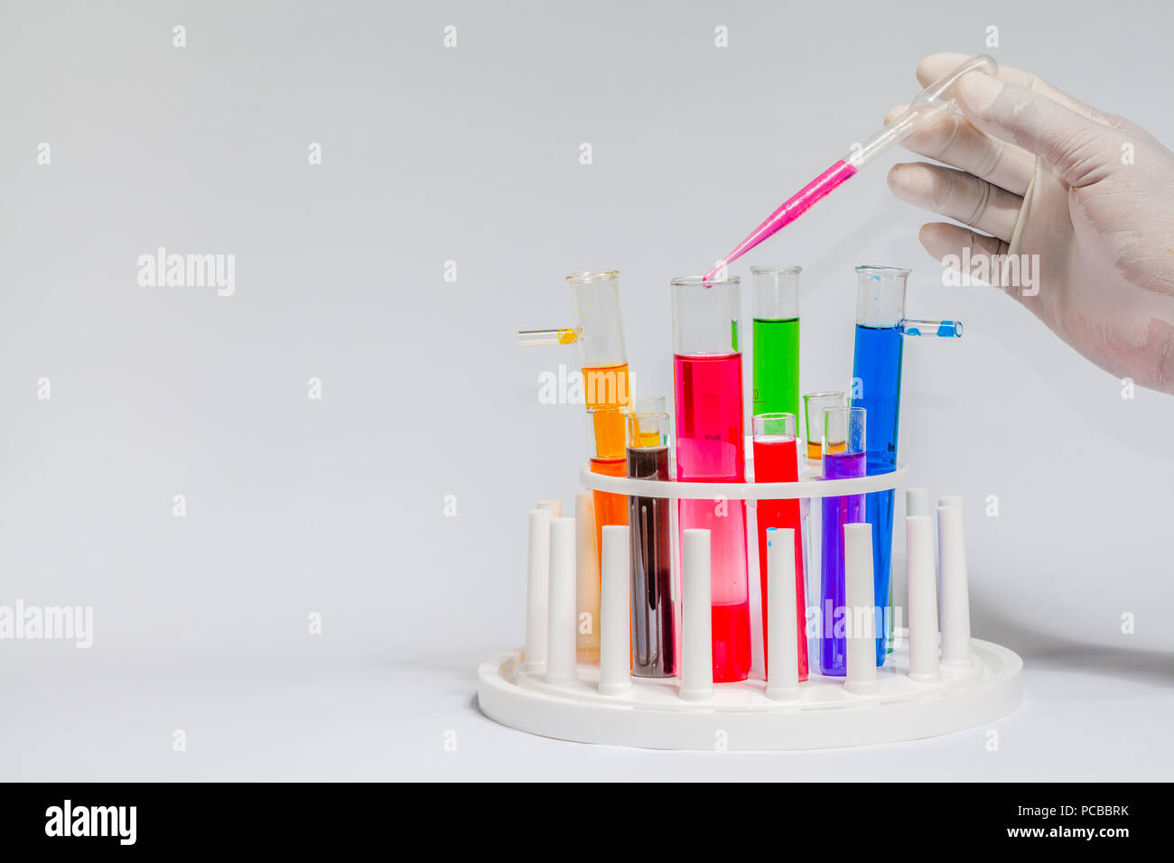Experiments in mixing chemical substances into glass tubes with a ...