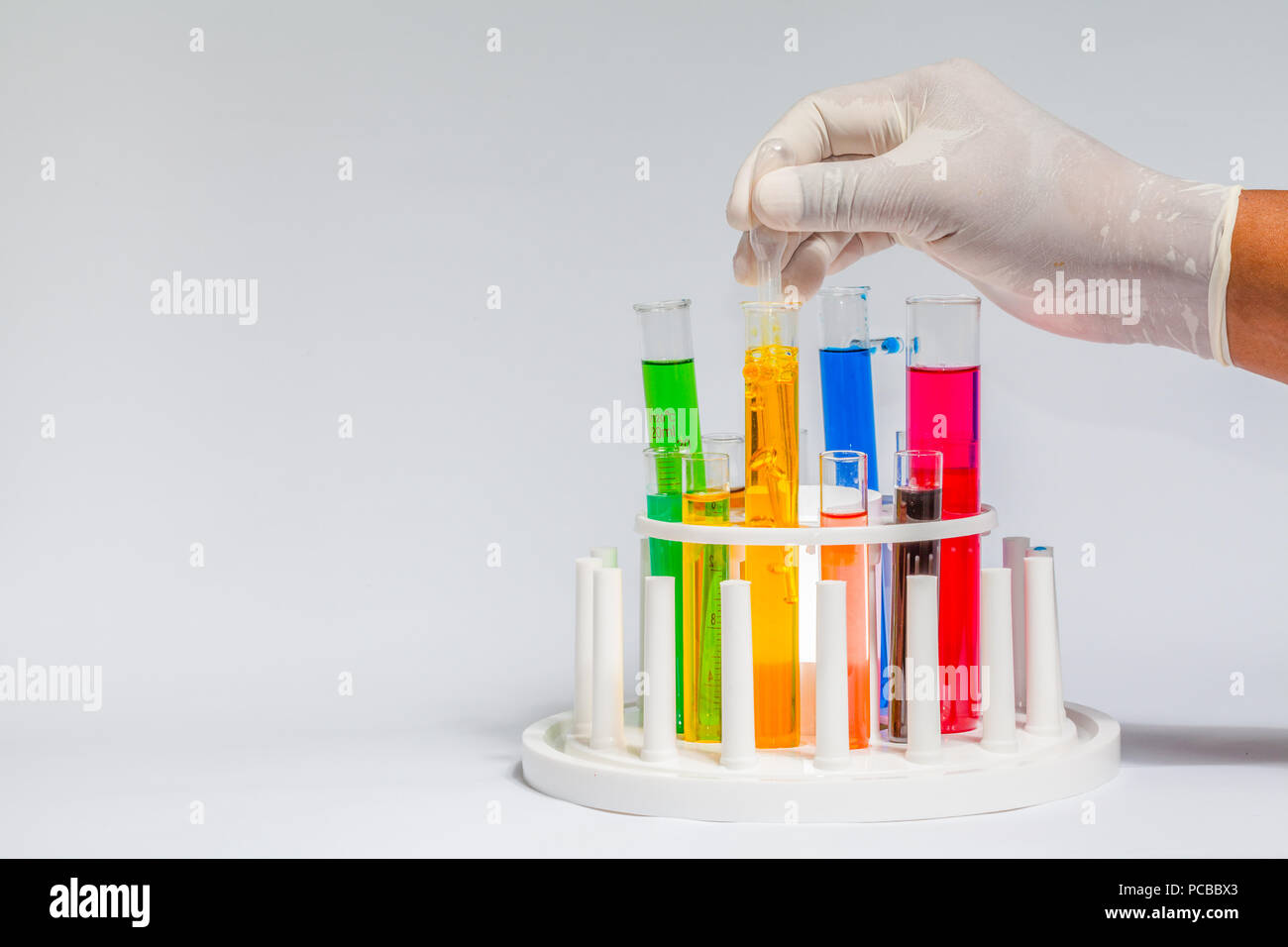 Experiments in mixing chemical substances into glass tubes with a ...