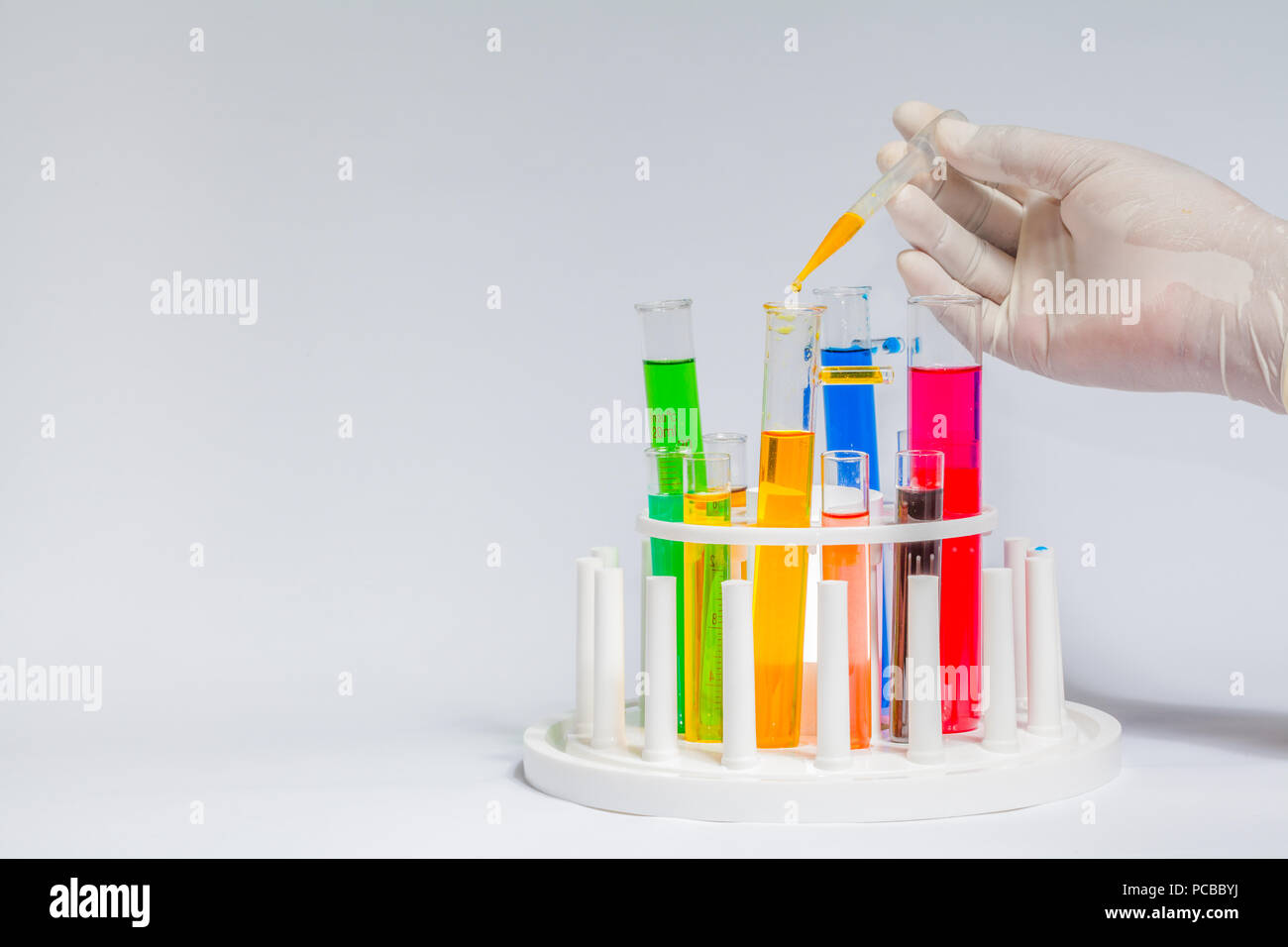 Experiments in mixing chemical substances into glass tubes with a ...
