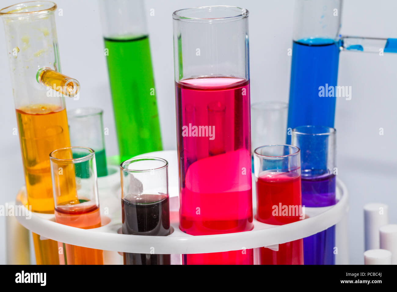 Experiments in mixing chemical substances into glass tubes with a ...