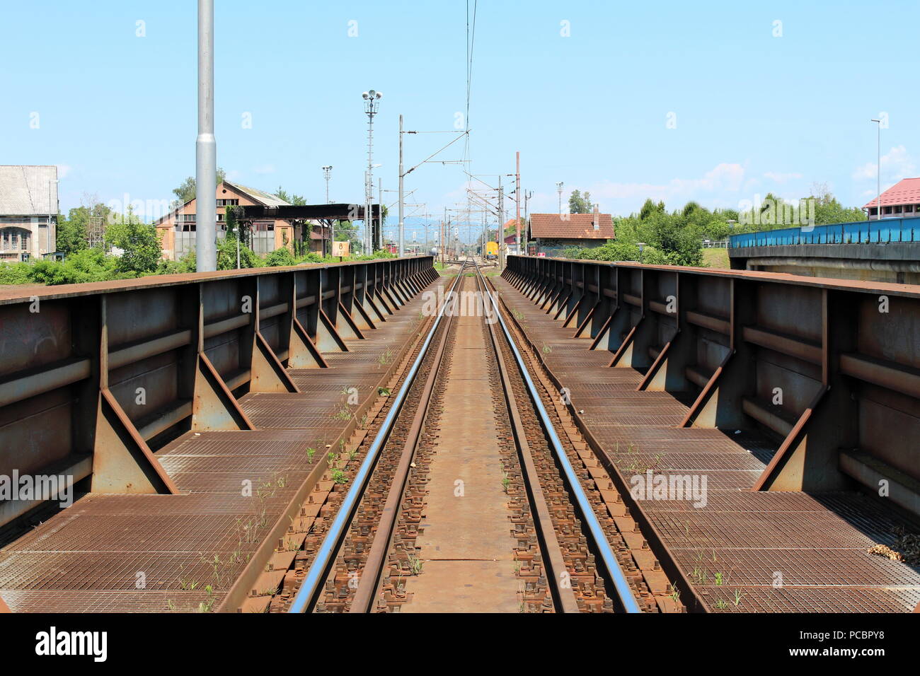 Completely rusted metal railway bridge leading to railway station ...