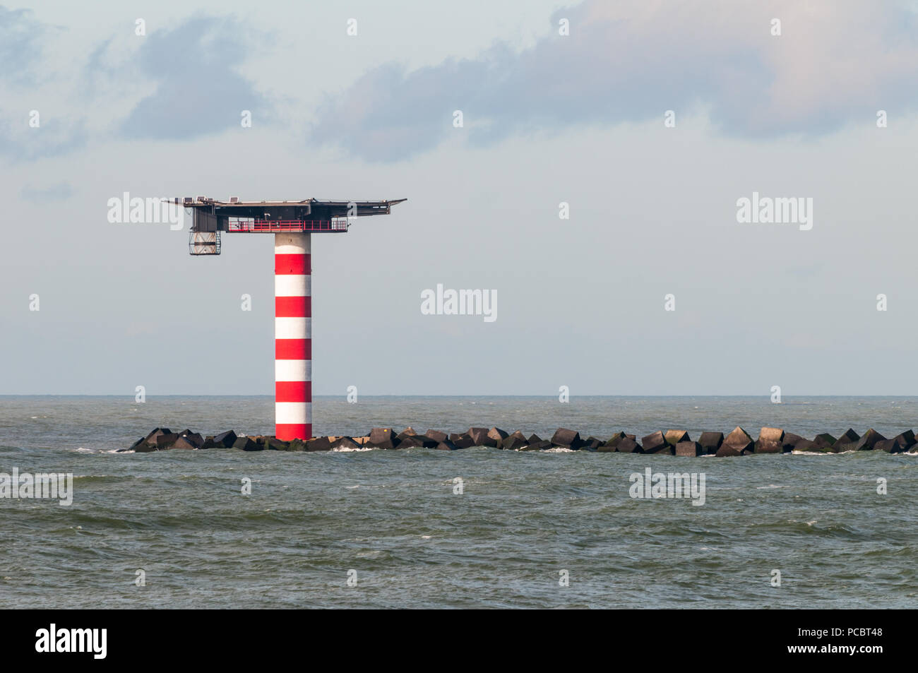 The red and white striped lighthouse with heliplatform at the entrance ...