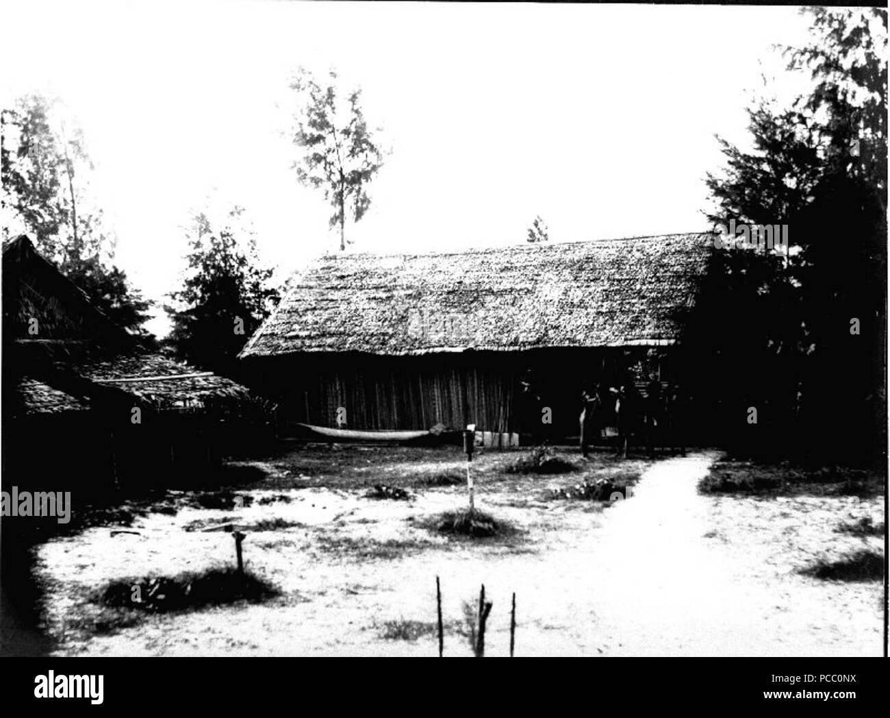 66 Papua's schieten met pijl en boog op het erf voor het huis van de ...