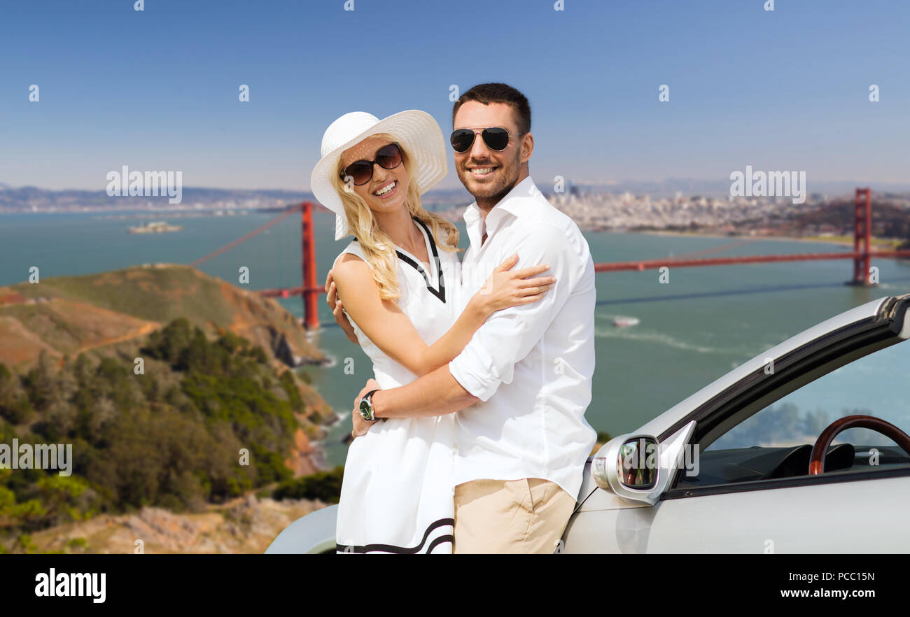 happy couple hugging near convertible car Stock Photo - Alamy