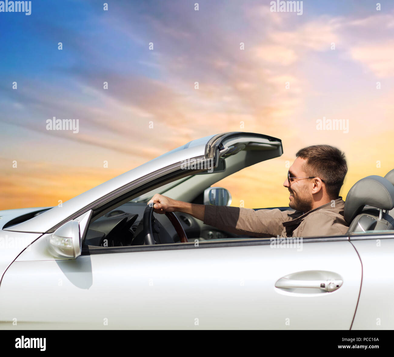 happy man driving convertible car over sky Stock Photo - Alamy