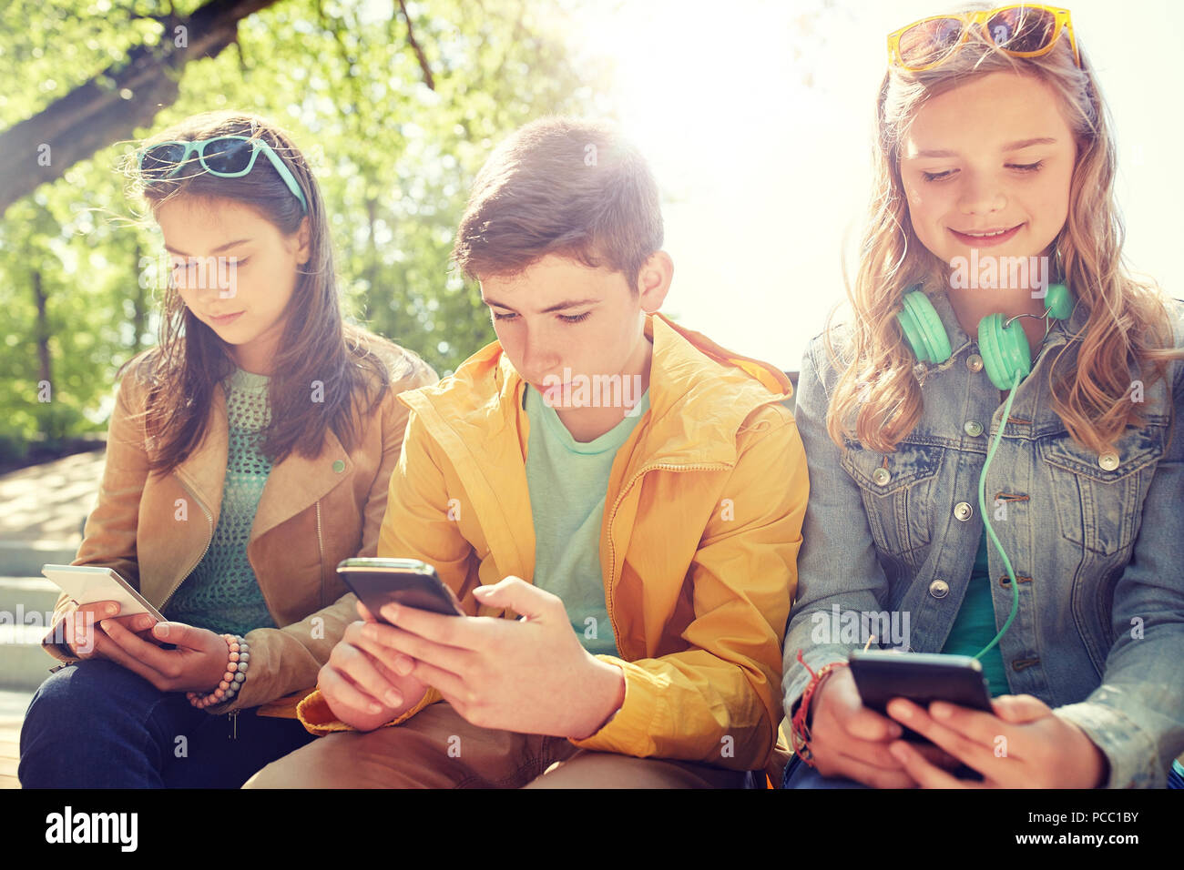 teenage friends with smartphone and headphones Stock Photo - Alamy