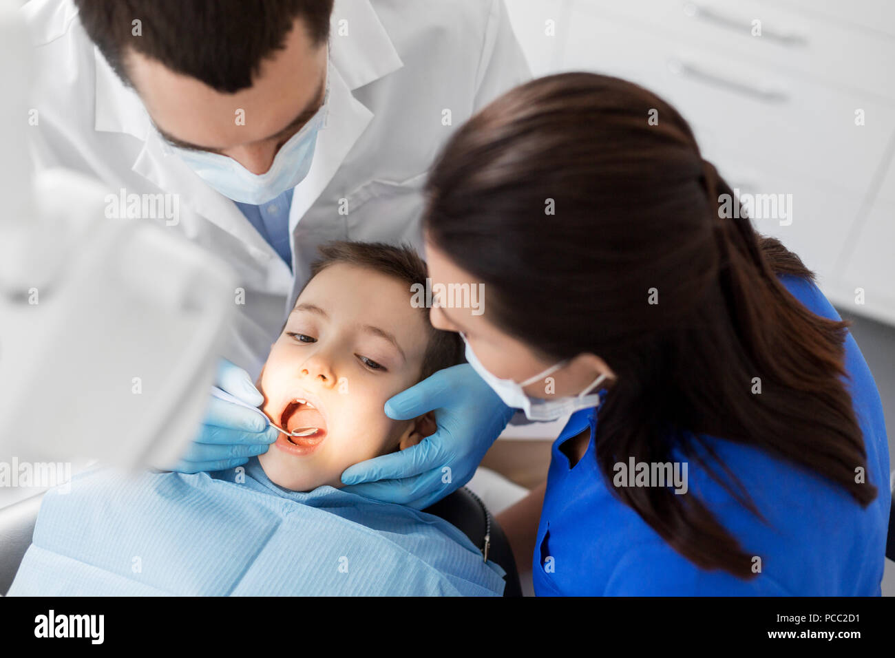 dentist checking for kid teeth at dental clinic Stock Photo - Alamy