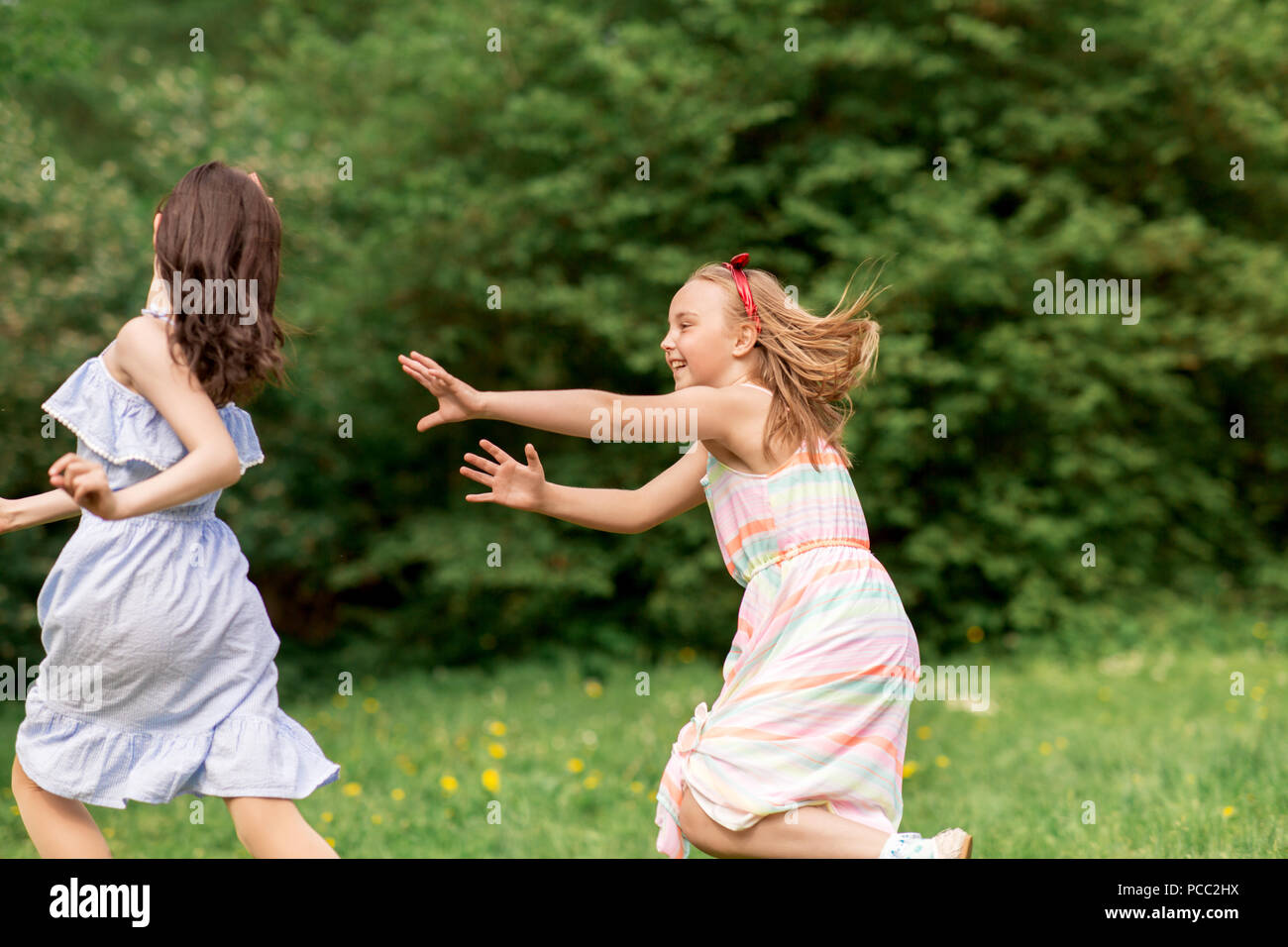 happy girls playing tag game at birthday party Stock Photo - Alamy
