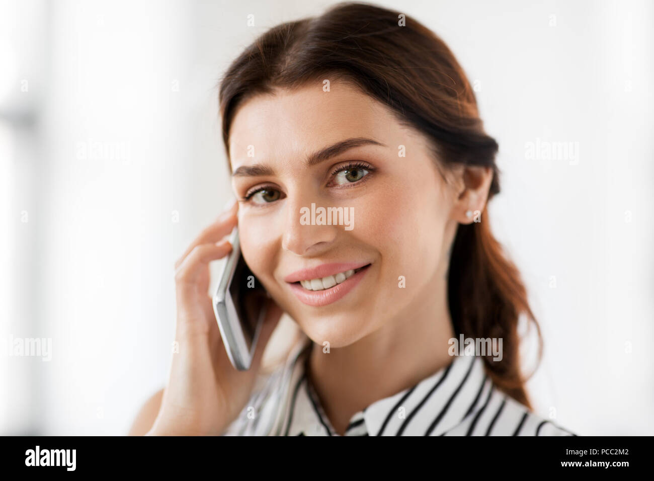 businesswoman calling on smartphone at office Stock Photo - Alamy