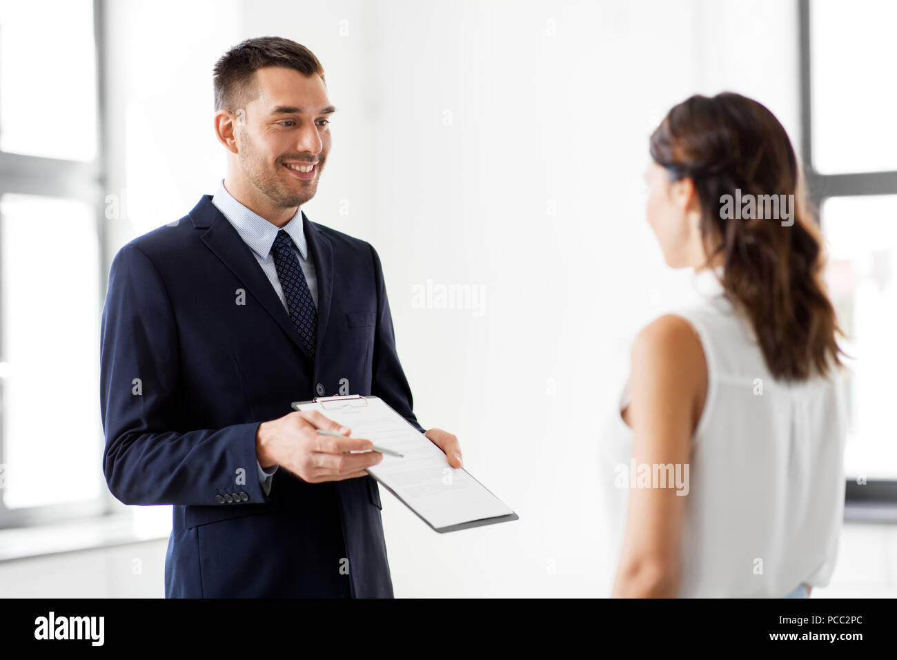realtor showing contract document to customer Stock Photo - Alamy