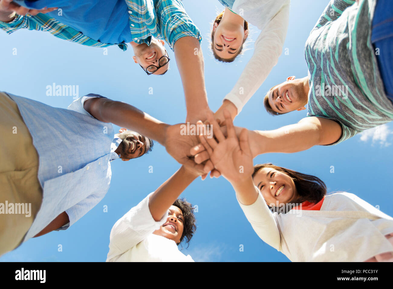happy smiling friends outdoors standing in circle Stock Photo - Alamy